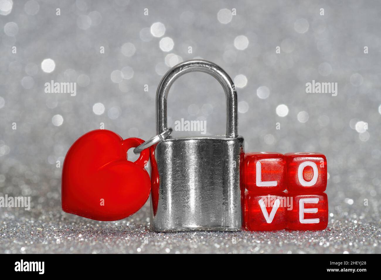 Locked padlock with a small heart pendant and LOVE word made from ...