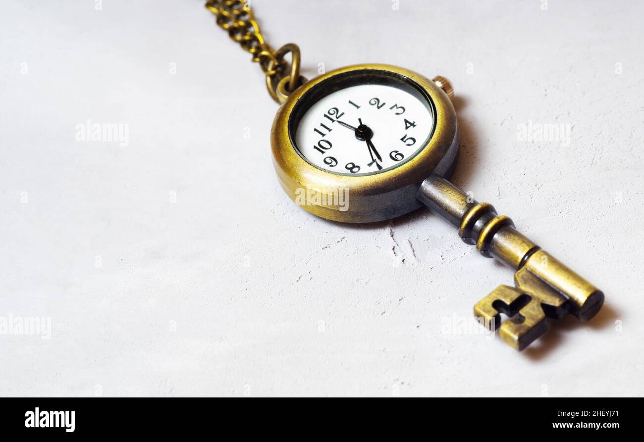Close-up of a retro style bronze toned key shaped pocket watch on a ...