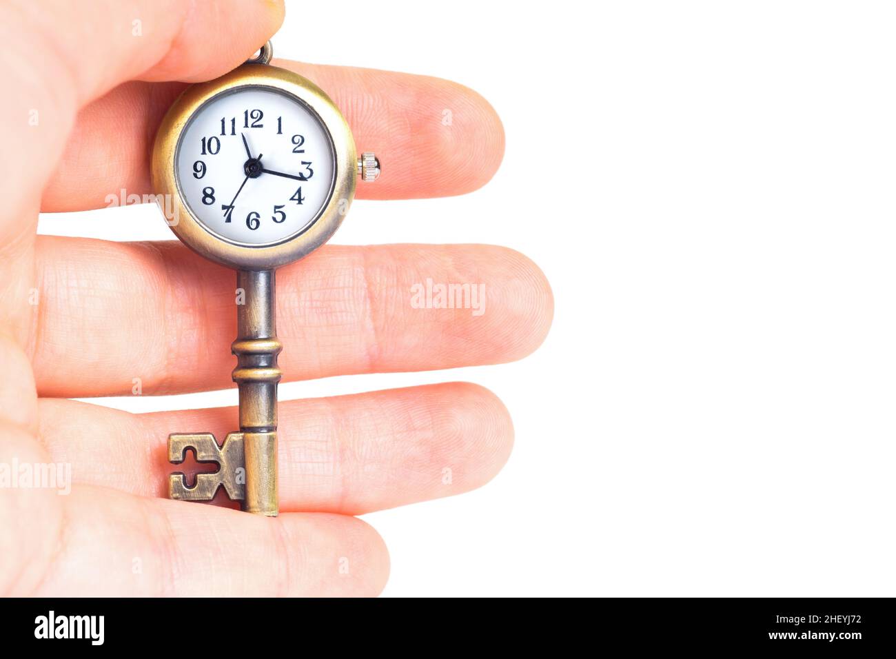 Close-up of a retro style bronze toned key shaped watch in hand ...