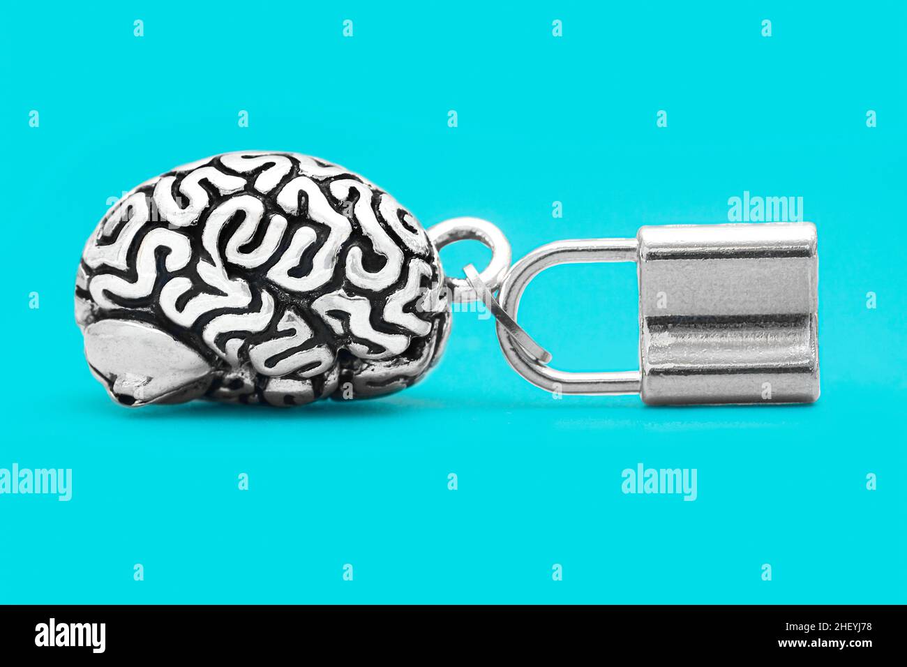 Steel copy of a human brain with a padlock isolated on blue background ...