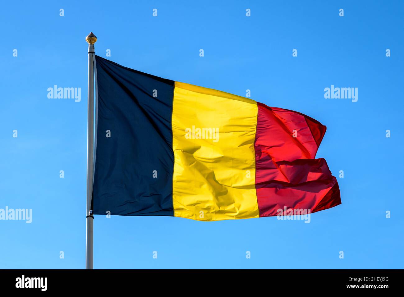 The national flag of Belgium is flying in the wind at full mast against ...