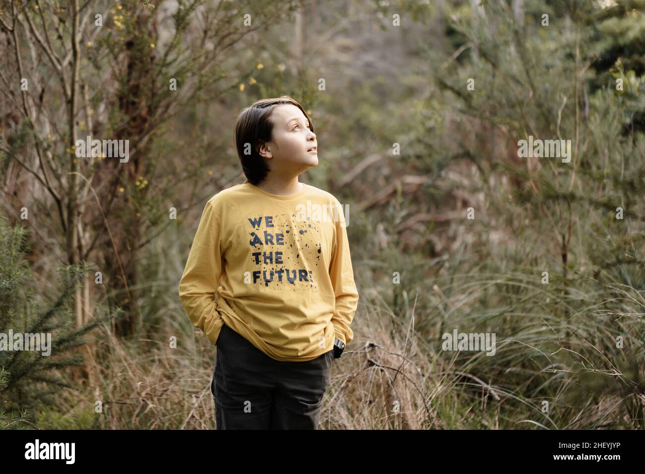Boy wearing a generic yellow T-shirt that says we are the future Stock ...