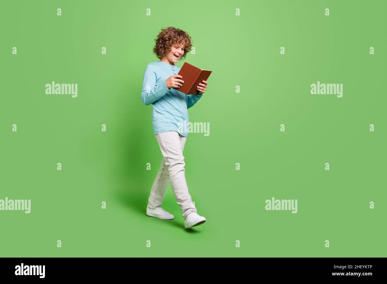 Full length body size view of attractive cheerful amazed guy reading ...