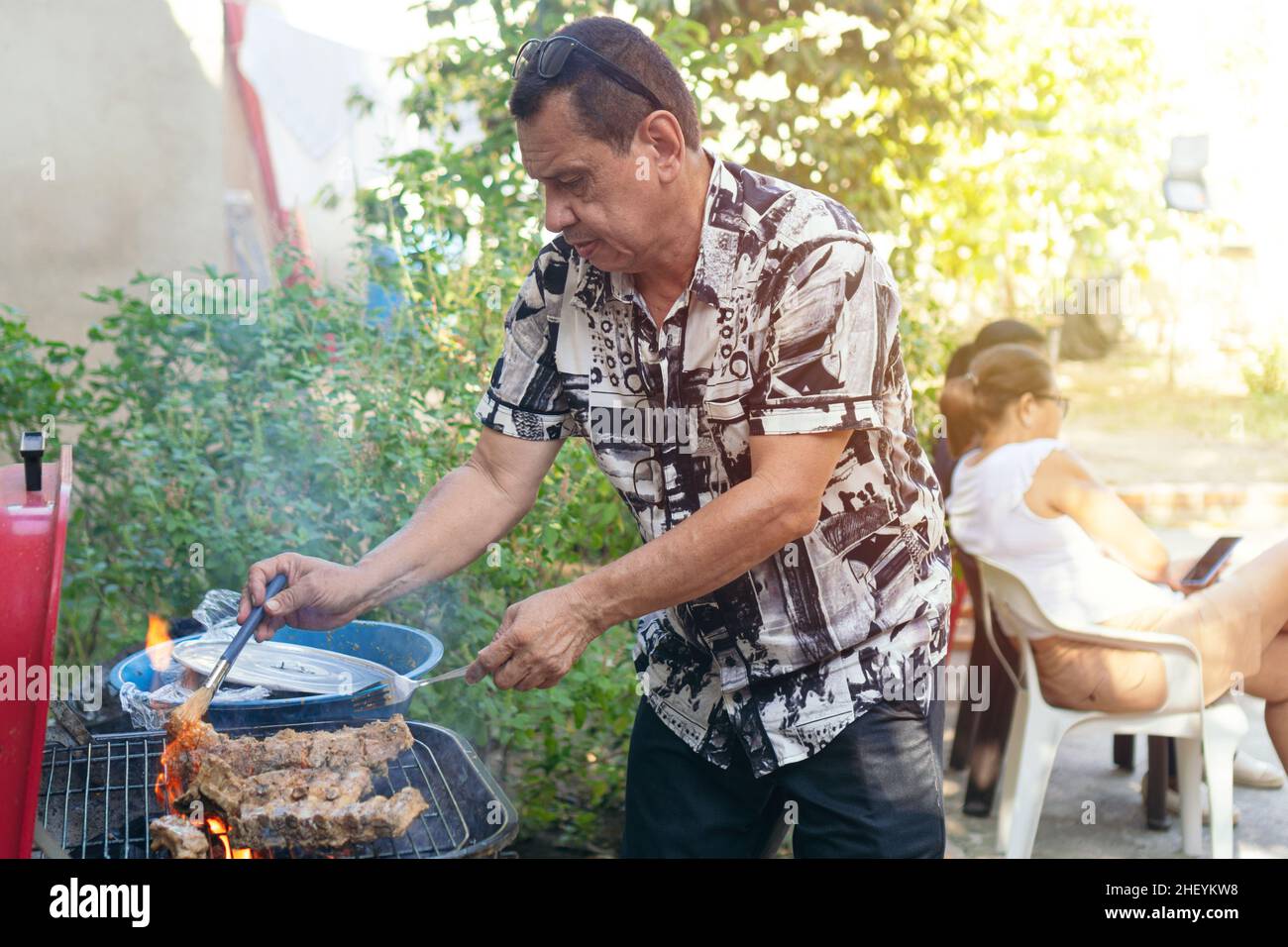 Family enjoying the weekend in their home. man preparing food for kids ...