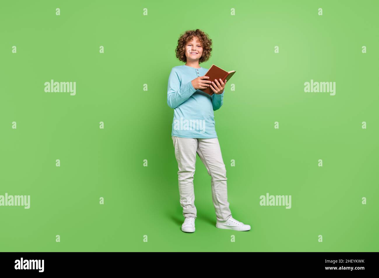 Full length body size view of attractive cheerful guy reading diary ...