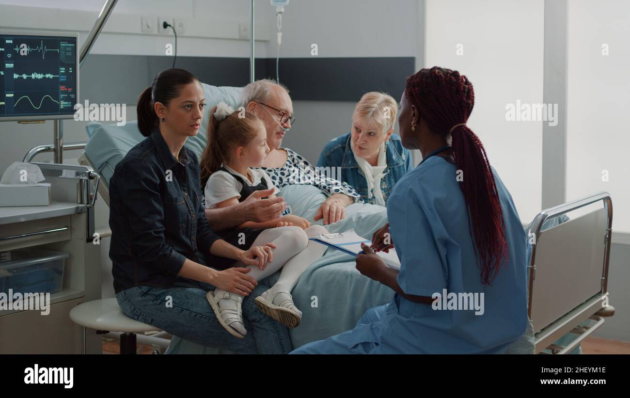 Medical assistant talking about diagnosis with woman in visit ...