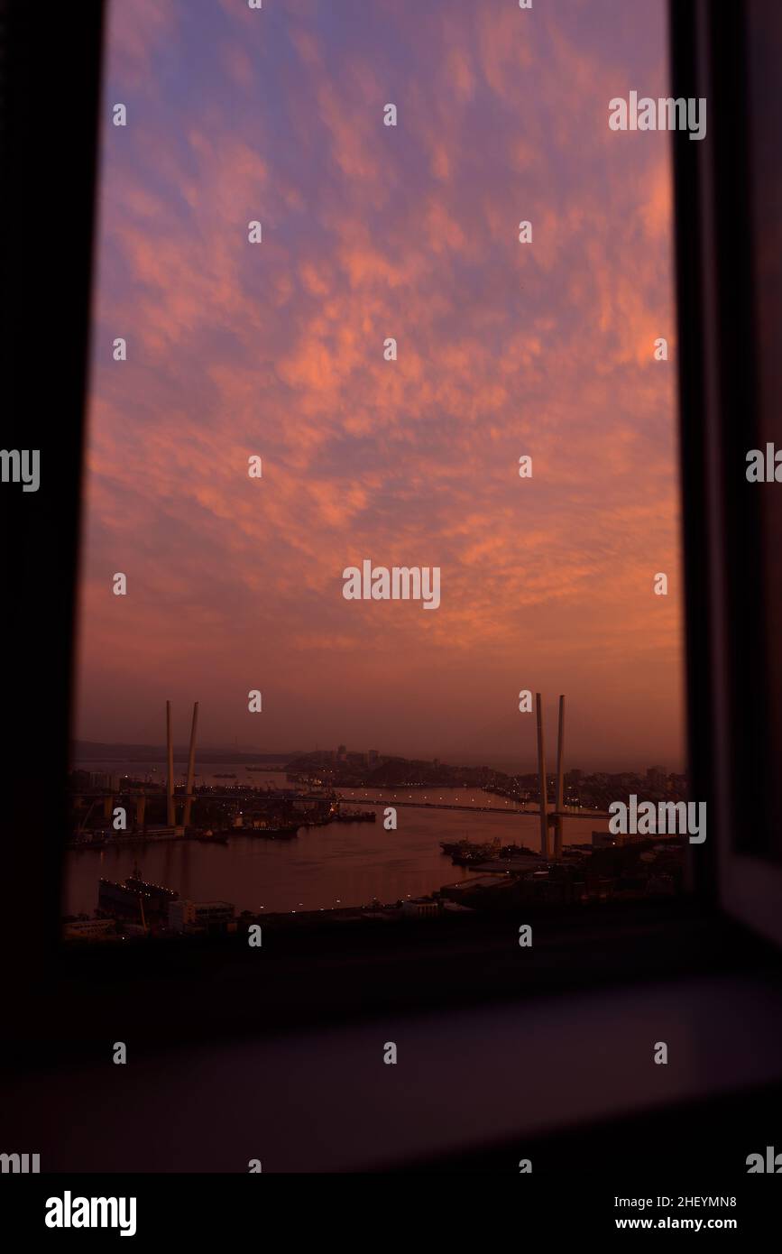 Sunset sky over city - view from window Stock Photo - Alamy