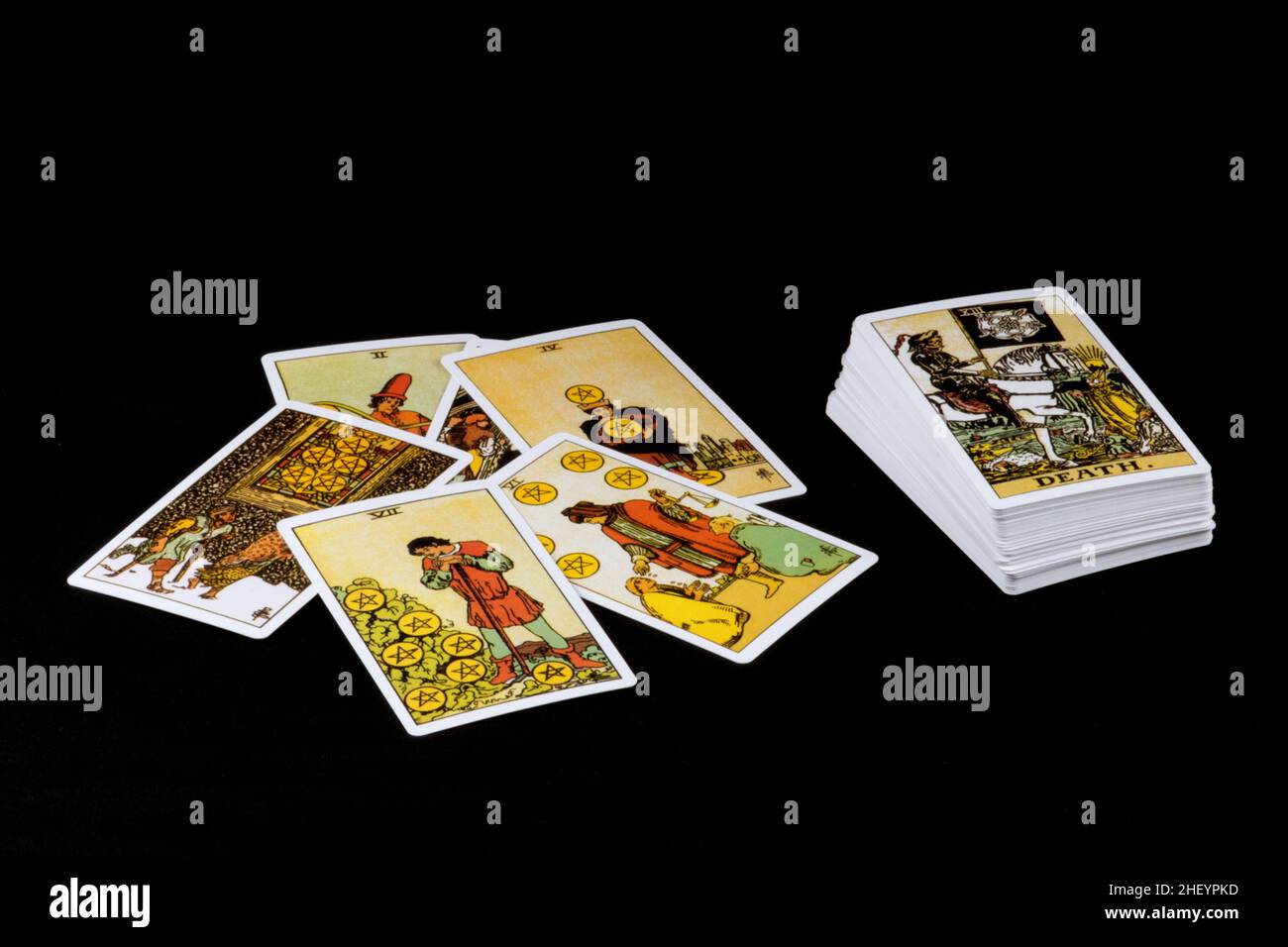Scattered tarot cards isolated on a black table top Stock Photo - Alamy