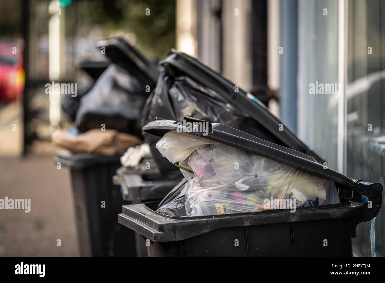 Overflowing domestic waste bins, UK Stock Photo - Alamy