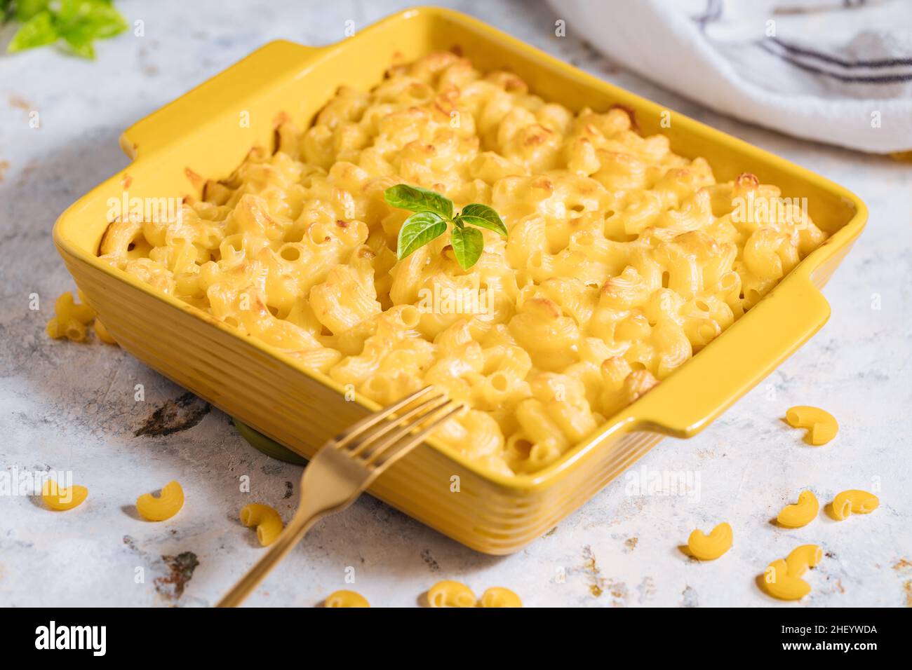 Classic mac and cheese with basil on top and mac and cheese baked in ...