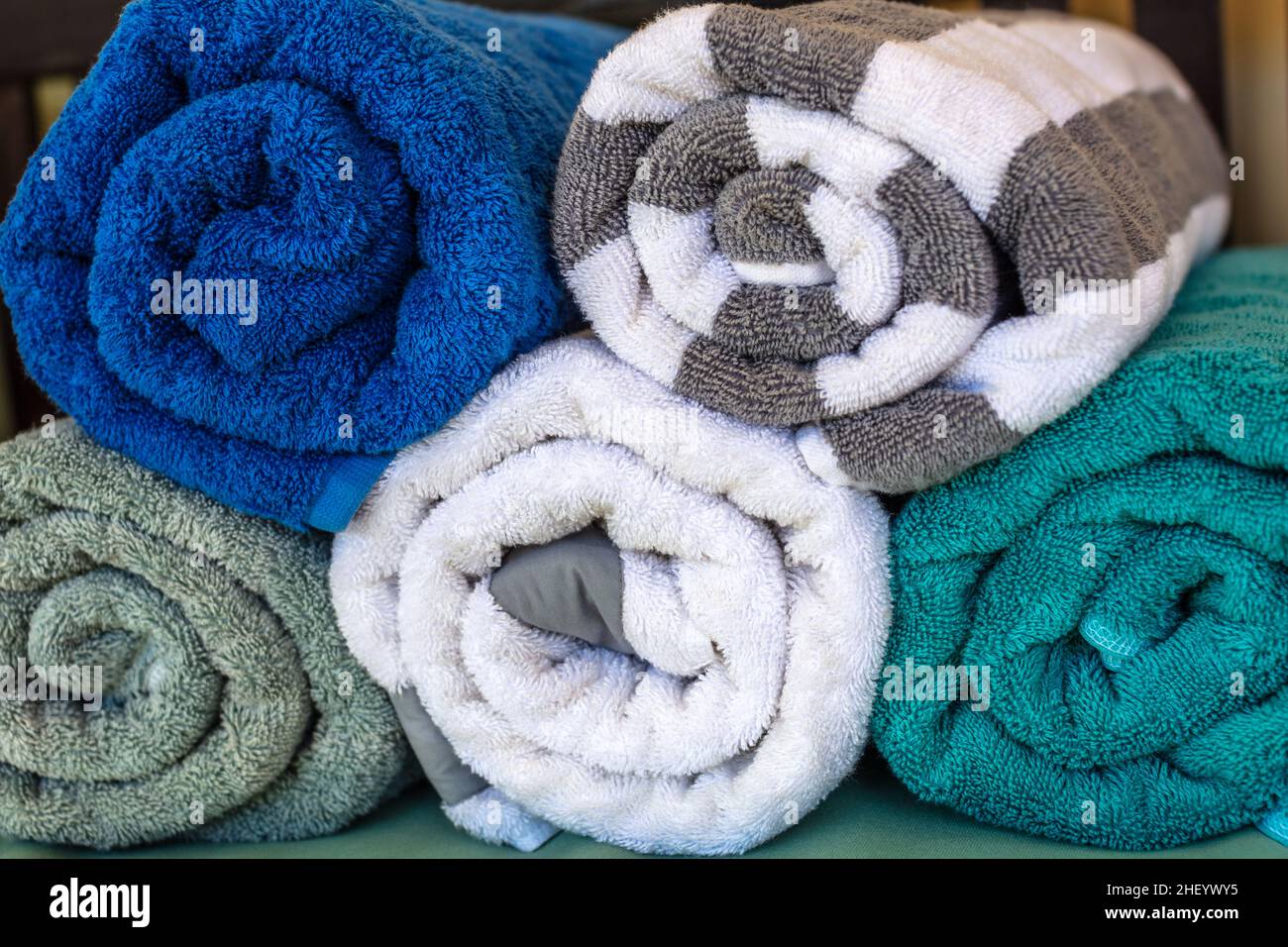 Stack of rolled colorful towels Stock Photo - Alamy