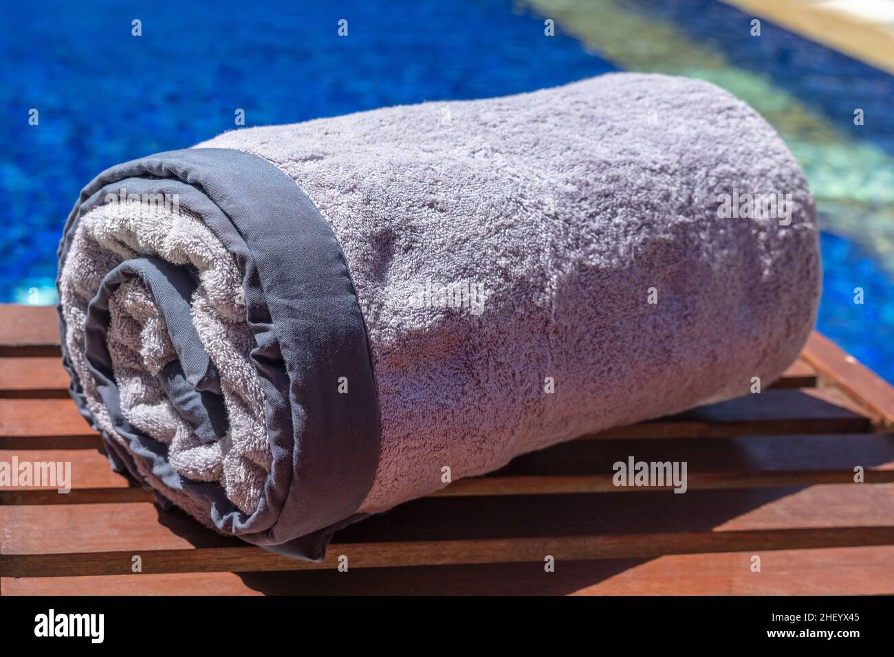 Rolled grey color two side towel near the swimming pool Stock Photo - Alamy
