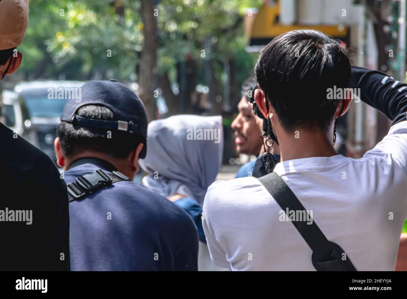 two young man photographer shooting with their own cameras with a ...