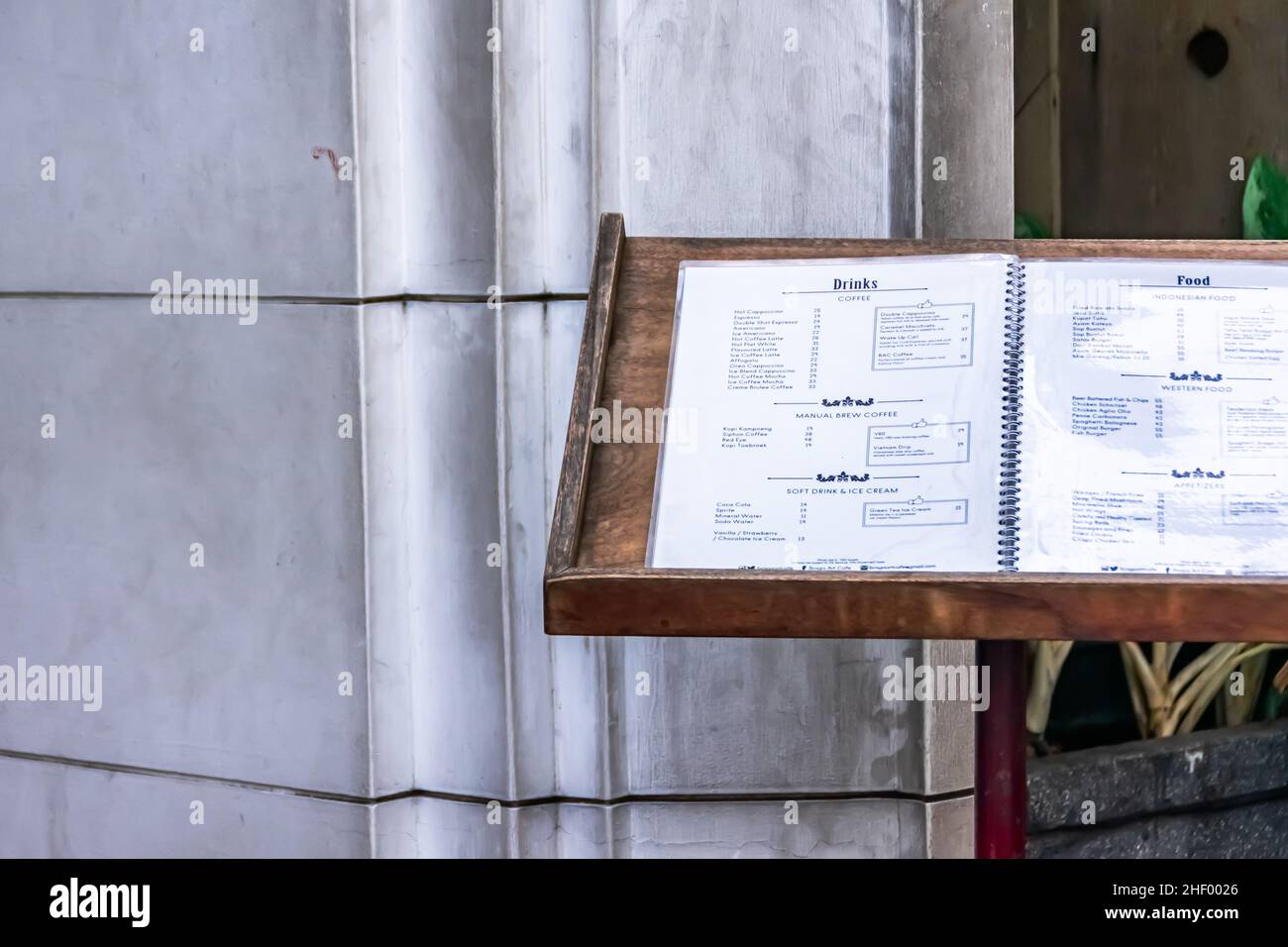 brown wooden table with food menu standing in the front of restaurant ...