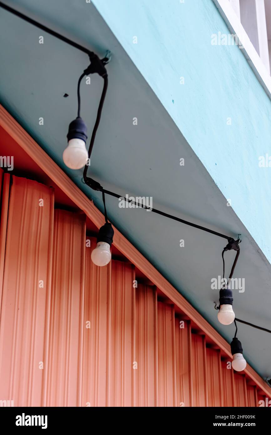 closed store front with pink color garage workshop door and the string ...