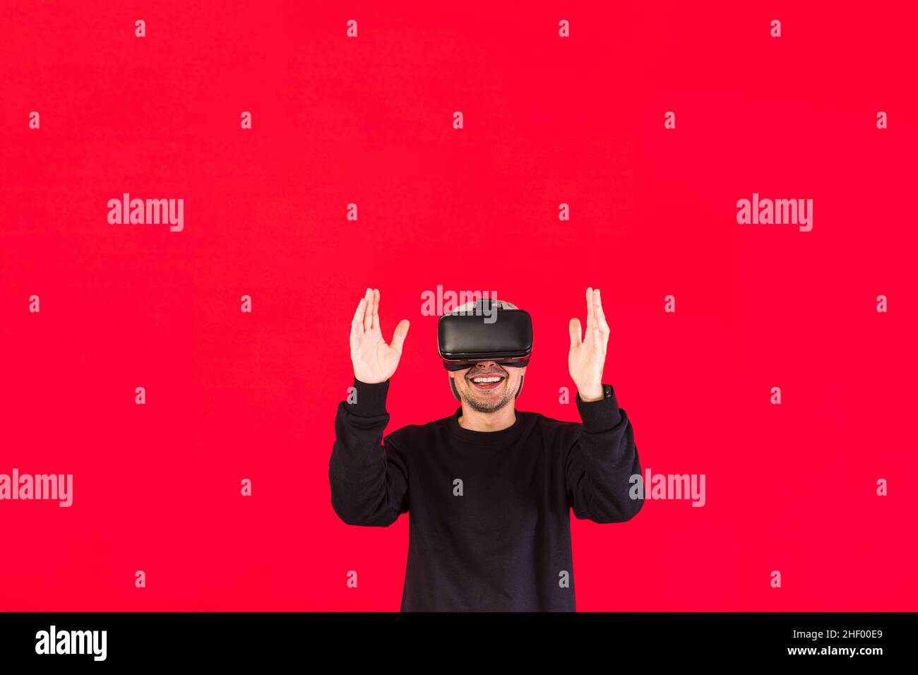 Man with cap dressed in black with Virtual Reality glasses smiling ...
