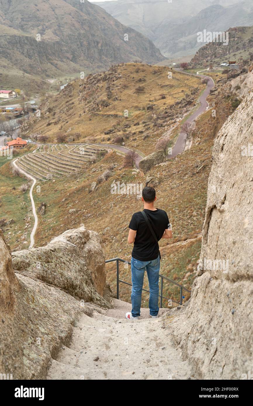 The guy the tourist walks between the stones exploring the ancient city ...