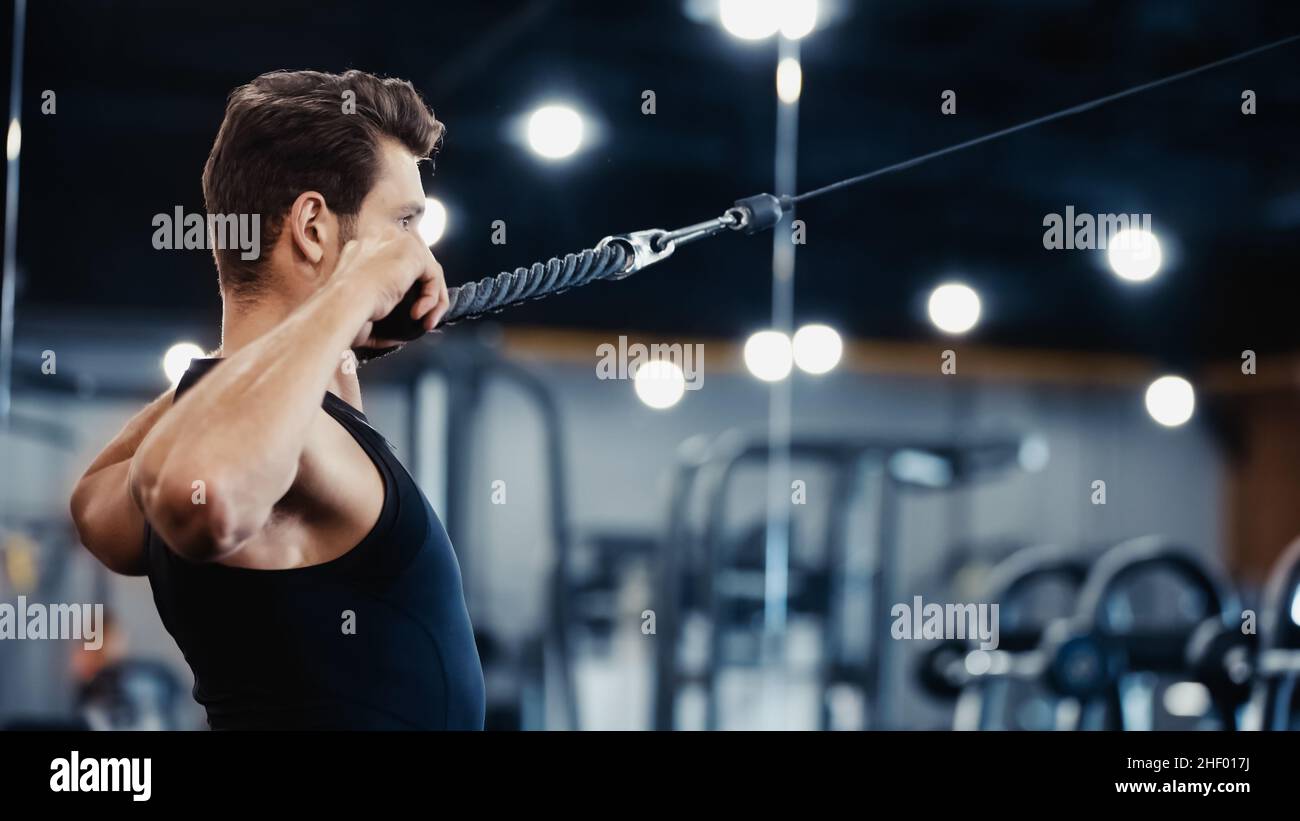side view of young sportsman exercising in gym Stock Photo - Alamy