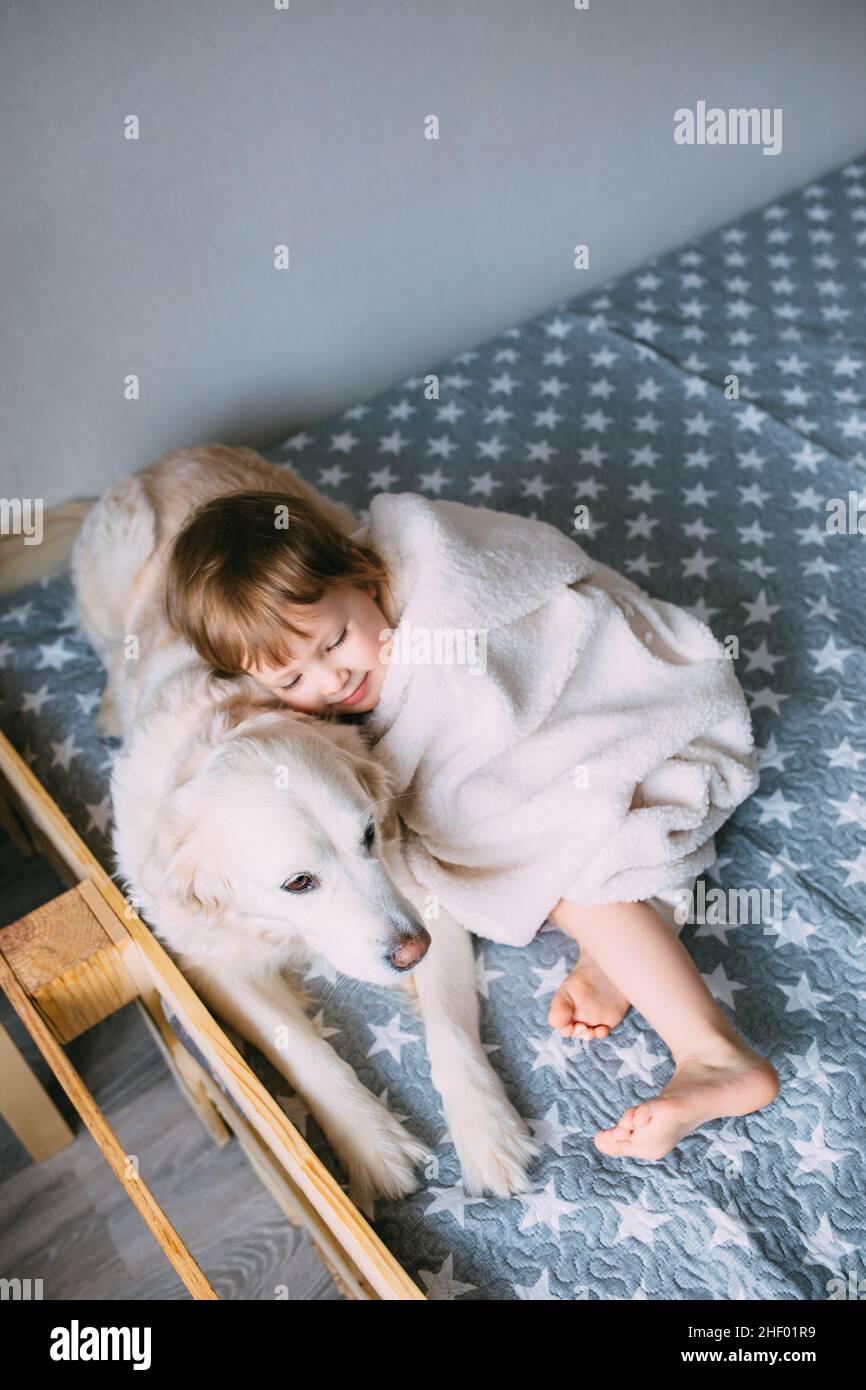 Cute baby and his labrador retriever at home on the bed Stock Photo - Alamy