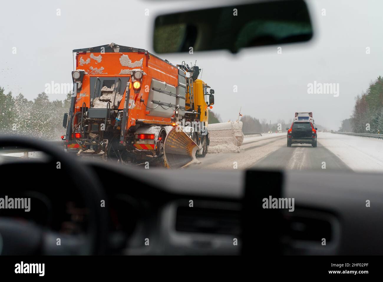 Difficult weather conditions on the road. Snow Plows clear the track ...
