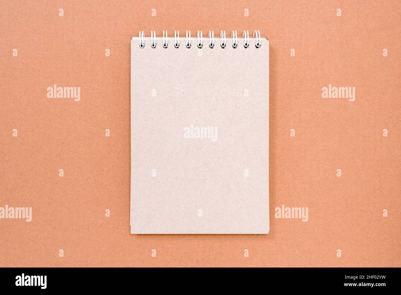 Blank spiral bound notepad on the cardboard background. Copy space ...