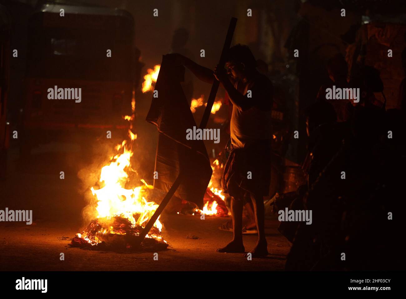 Chennai, Tamil Nadu, India. 13th Jan, 2022. A man puts the old clothes ...