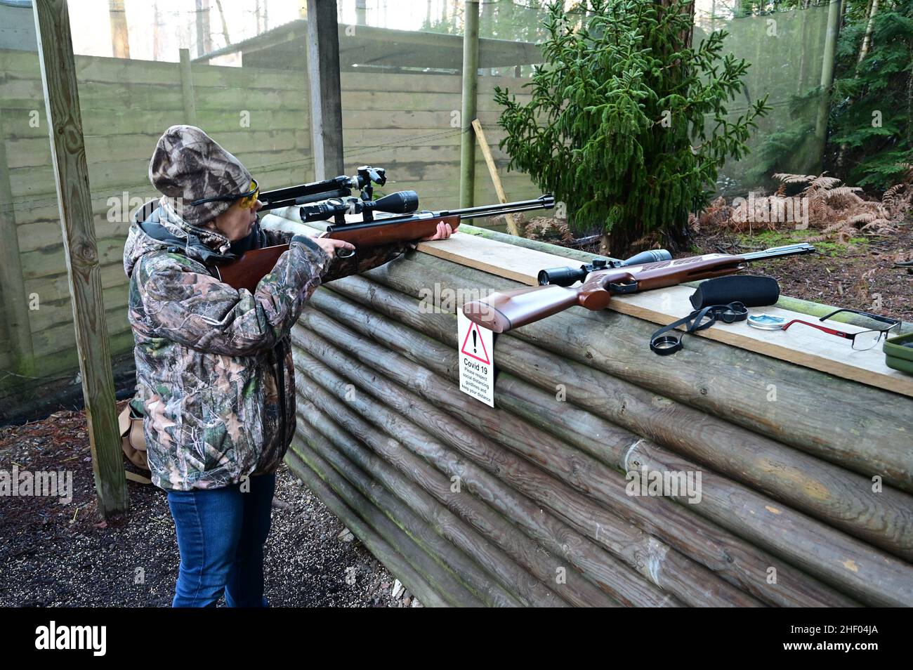 A Lady shooting a rifle at a shooting range Stock Photo - Alamy