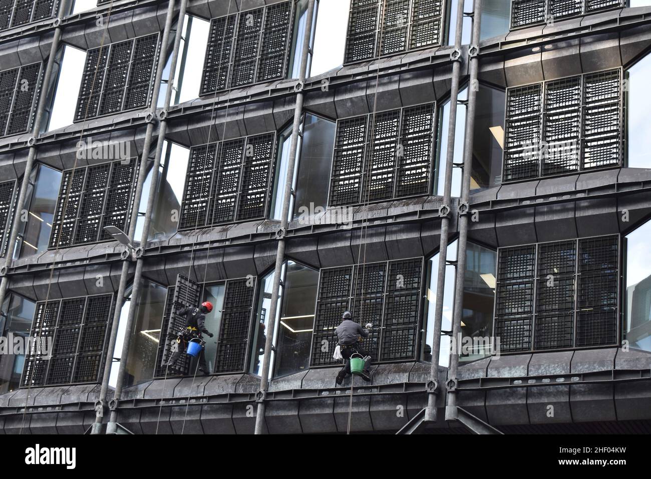 Workers cleaning windows of modern office building at Queen Victoria ...