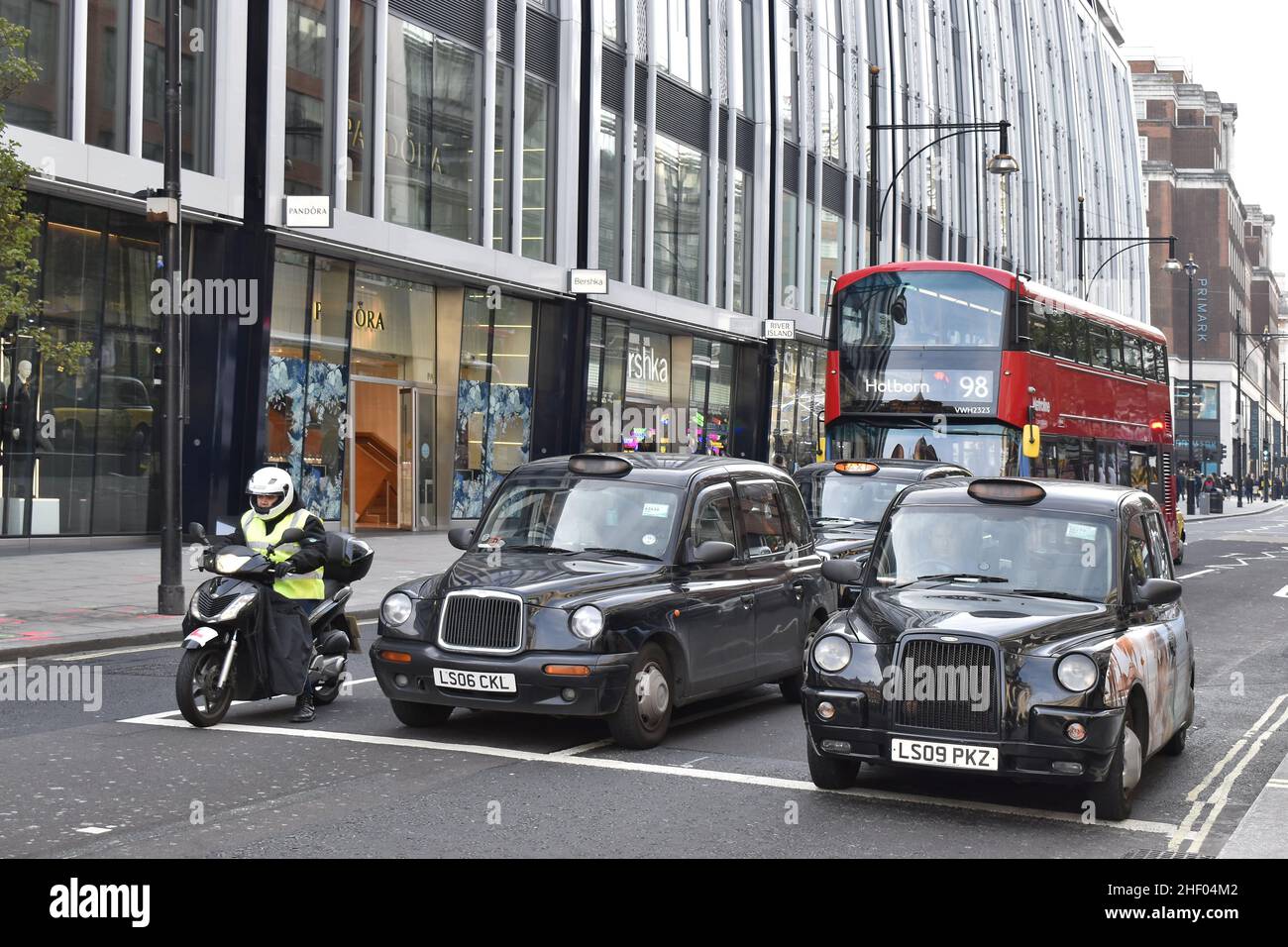 Black cabs and double-decker bus at Oxford Street in London UK Stock ...