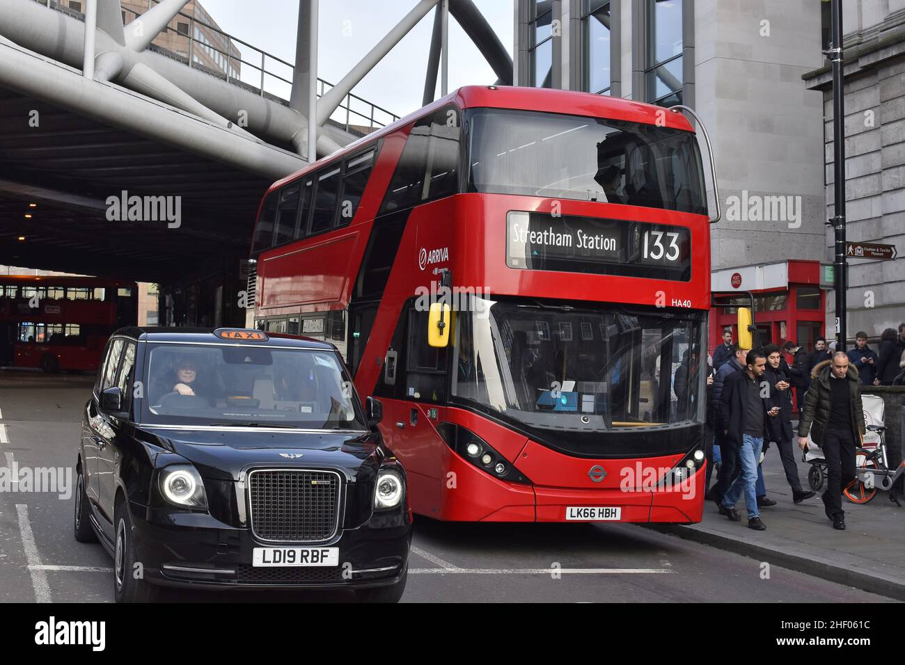 Black cab and red double decker bus near London Bridge station ...