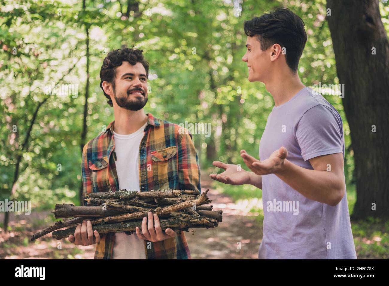 Portrait of attractive cheerful two people spending free time in wild ...