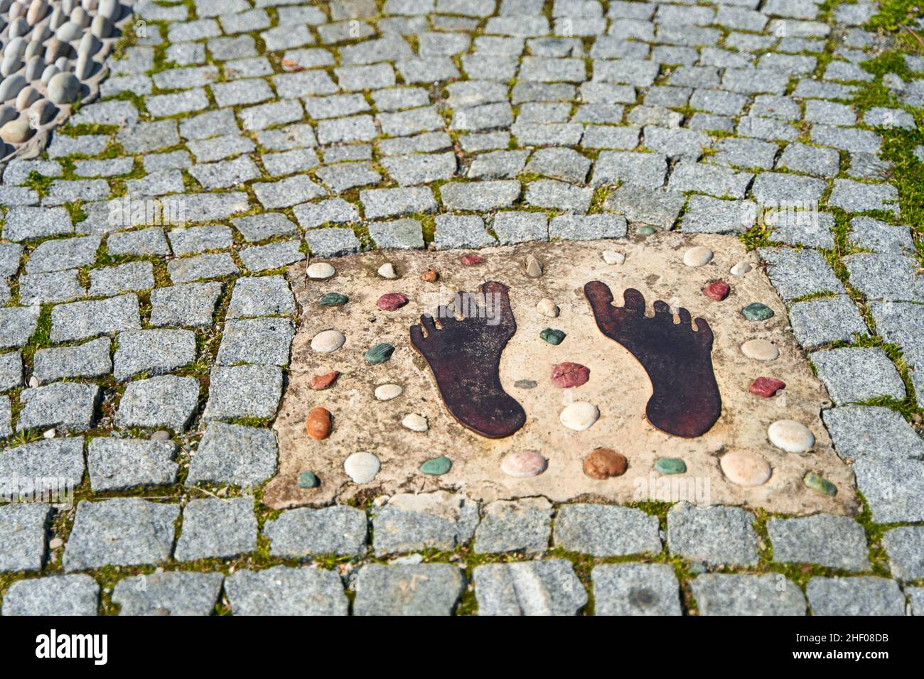 A trail made of small stones for foot massage on the promenade by the ...