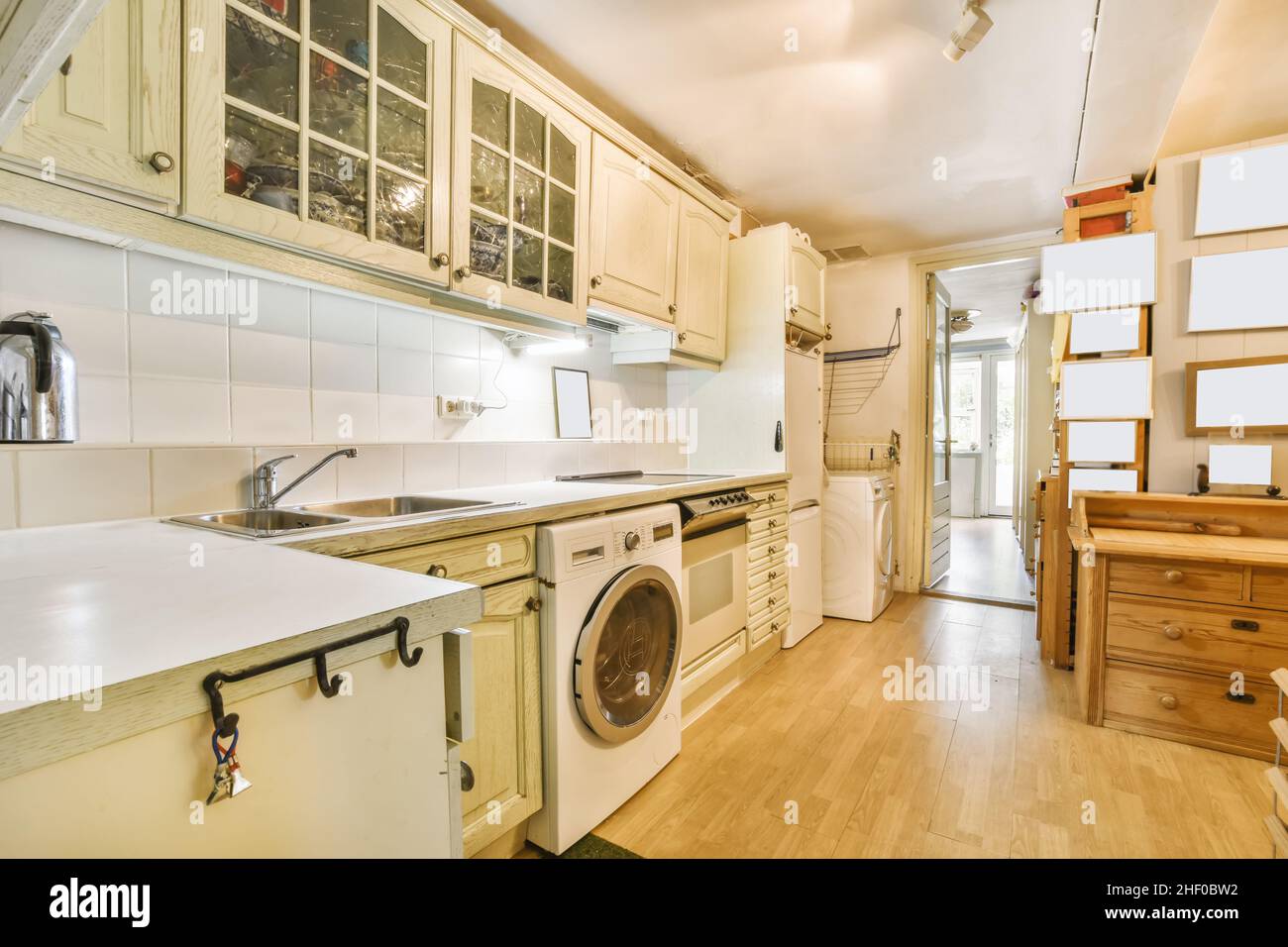 Nice kitchen in light colors with a washing machine built into the ...