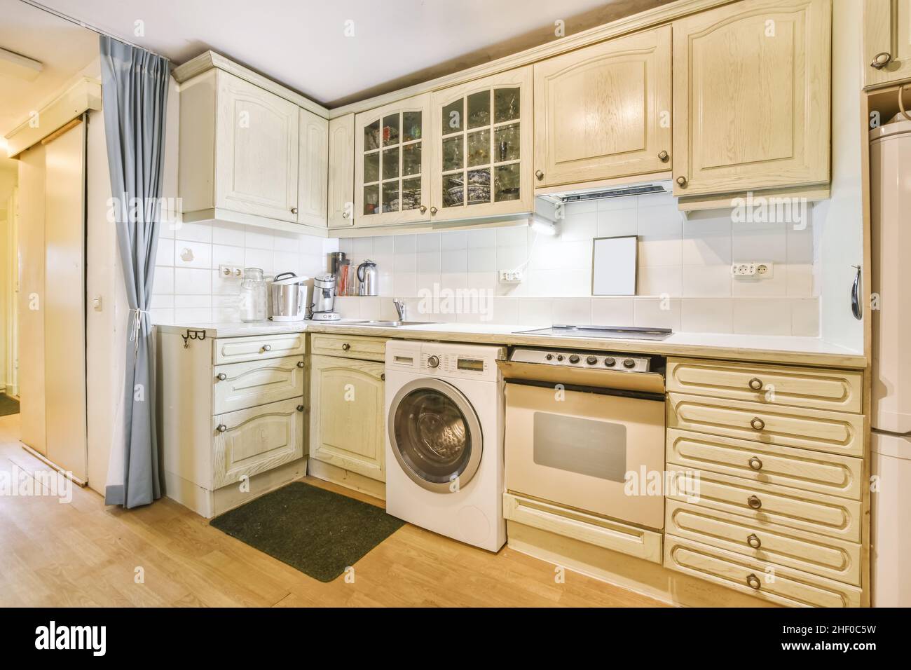 Nice kitchen in light colors with a washing machine built into the ...