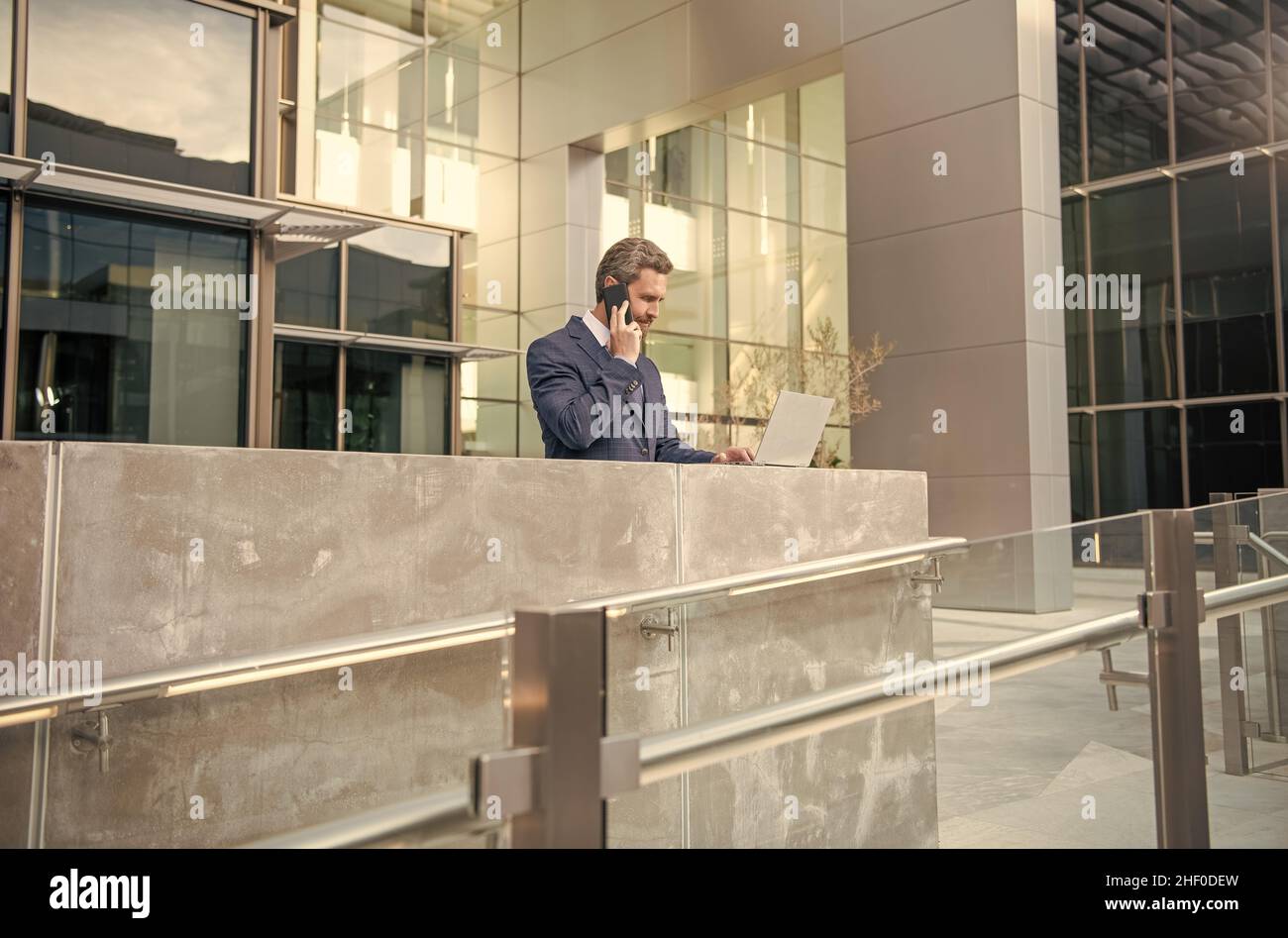 busy business man in formalwear work online on computer using phone ...