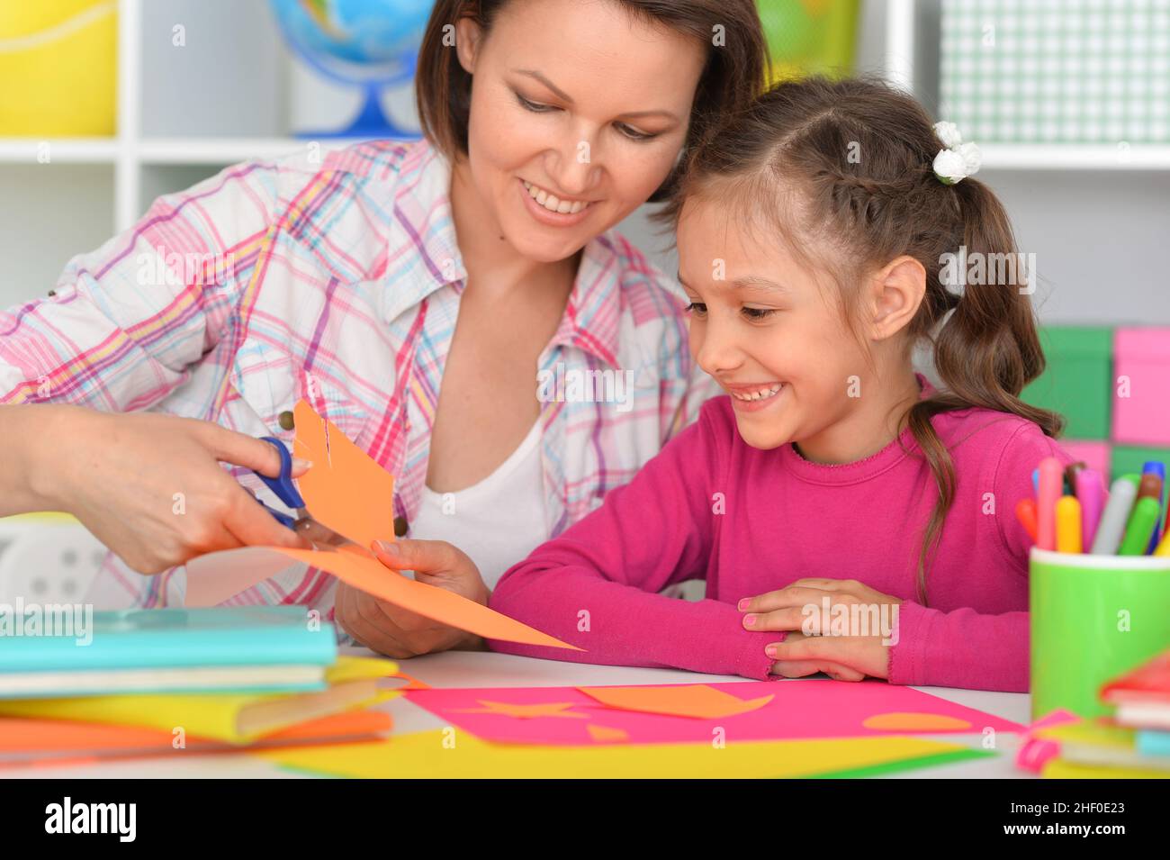 Mother teaches her cute daughter to do craft items Stock Photo - Alamy