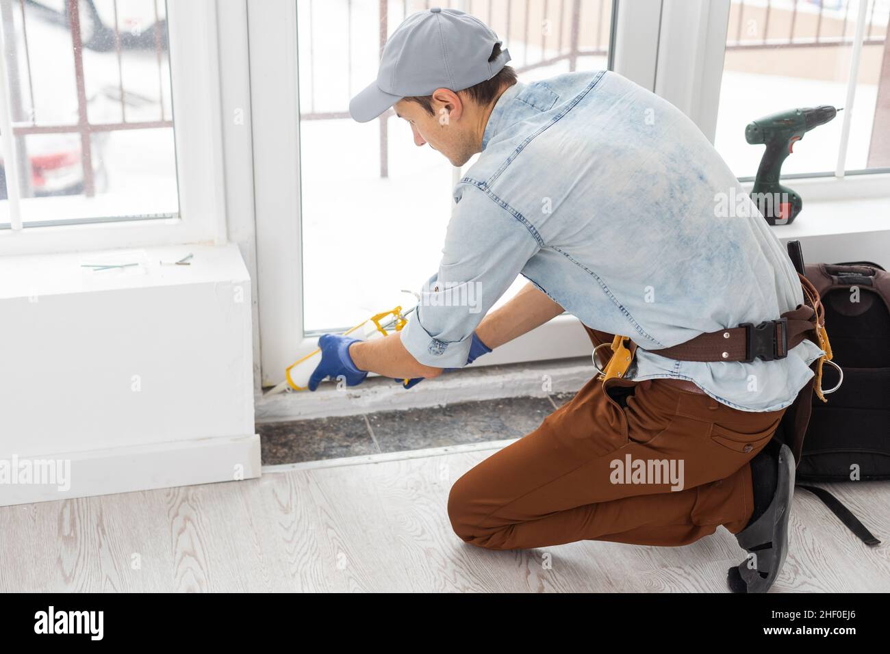 The worker installing and checking window in the house Stock Photo - Alamy