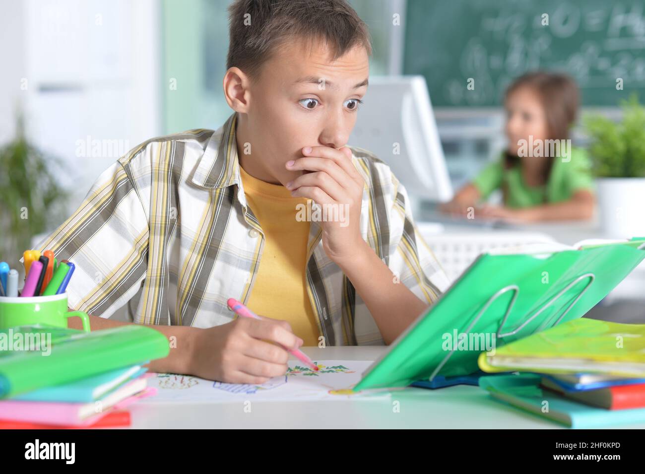 Portrait of a boy drawing with pencil Stock Photo - Alamy