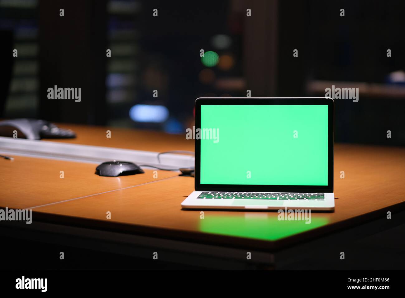 green screen laptop computer on table in office meeting room at night ...