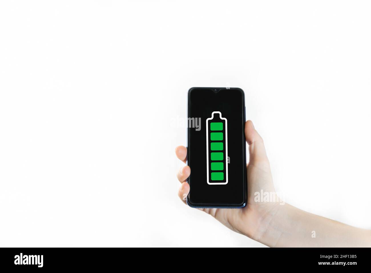 Hand holding phone with full battery on screen isolated on white ...