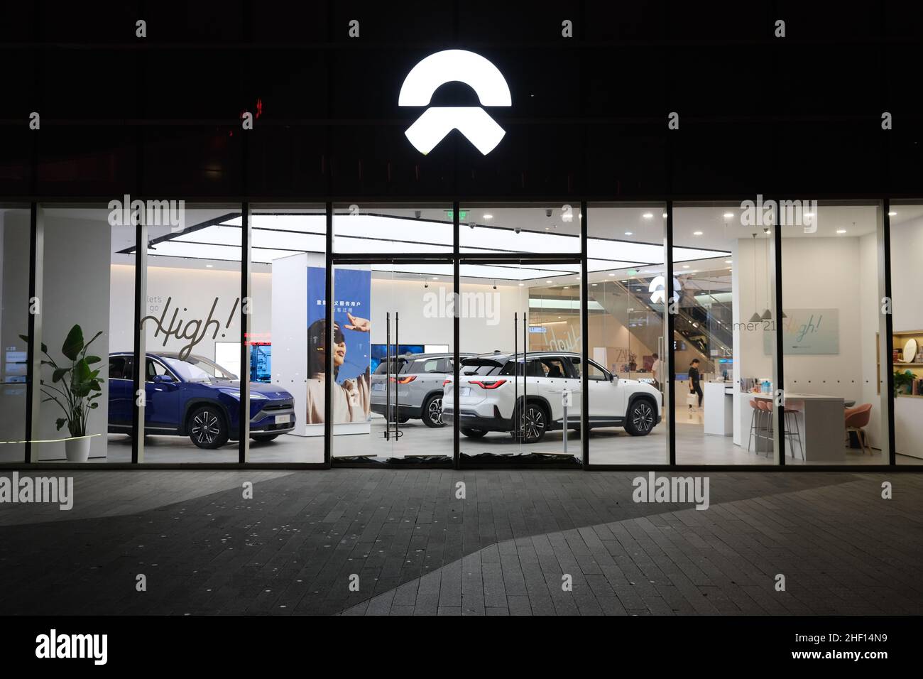 facade exterior of NIO electric car store at night. NIO is a Chinese EV ...