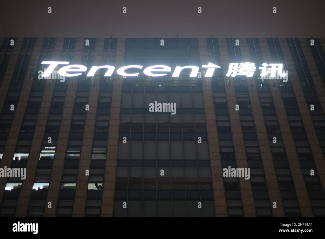 Tencent company logo on office building at night. A Chinese ...