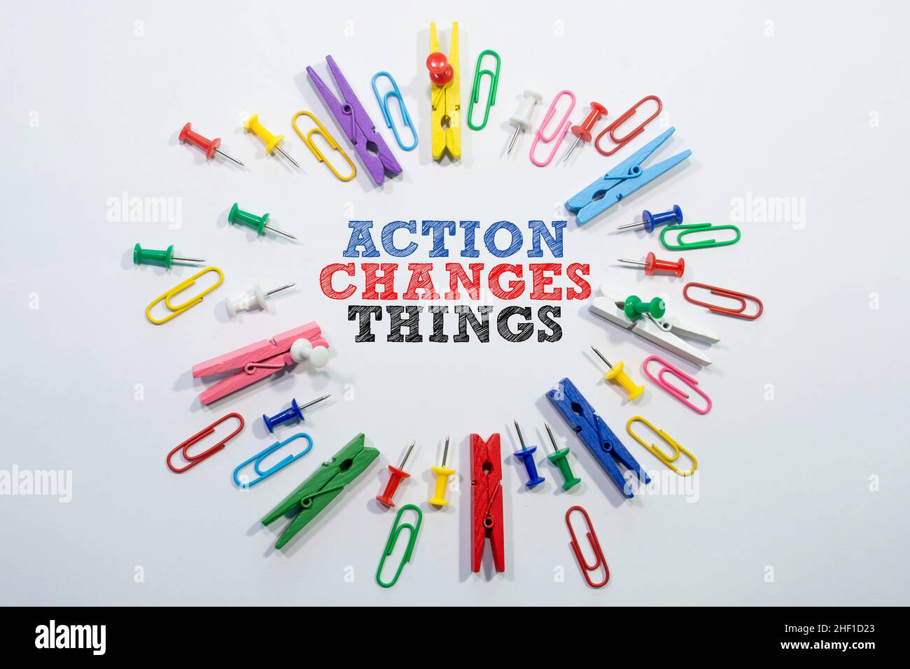 Text sign showing Action Changes Things with office stationery clips ...