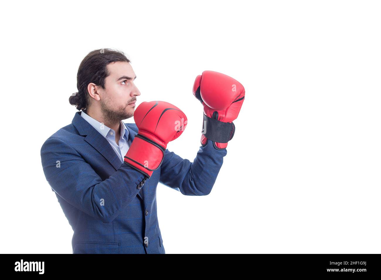 Businessman with red boxing gloves stands in fighting position. Side ...