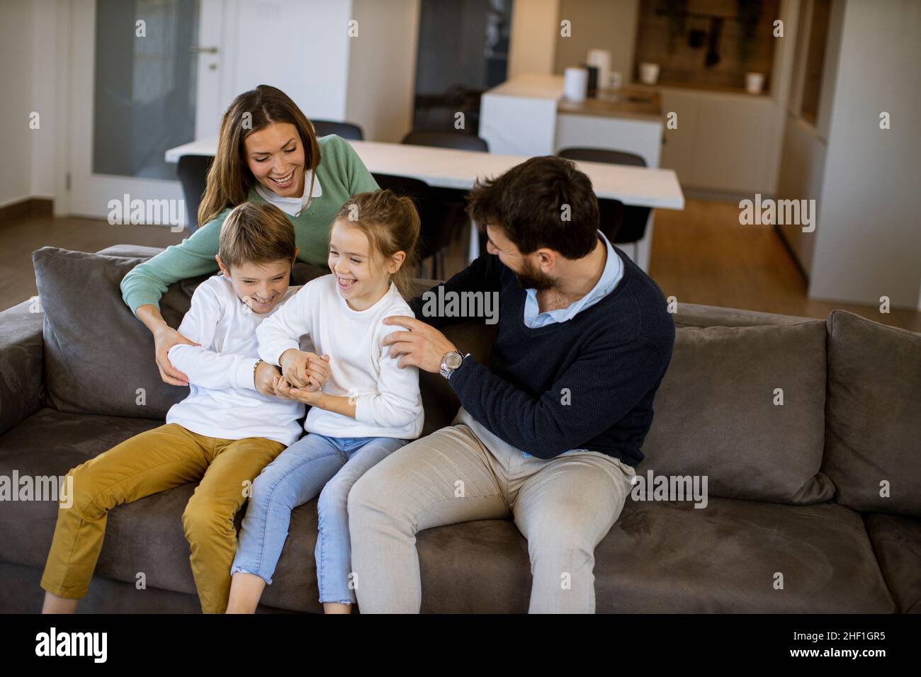 Cute siblings fighting over TV remote control at home Stock Photo - Alamy