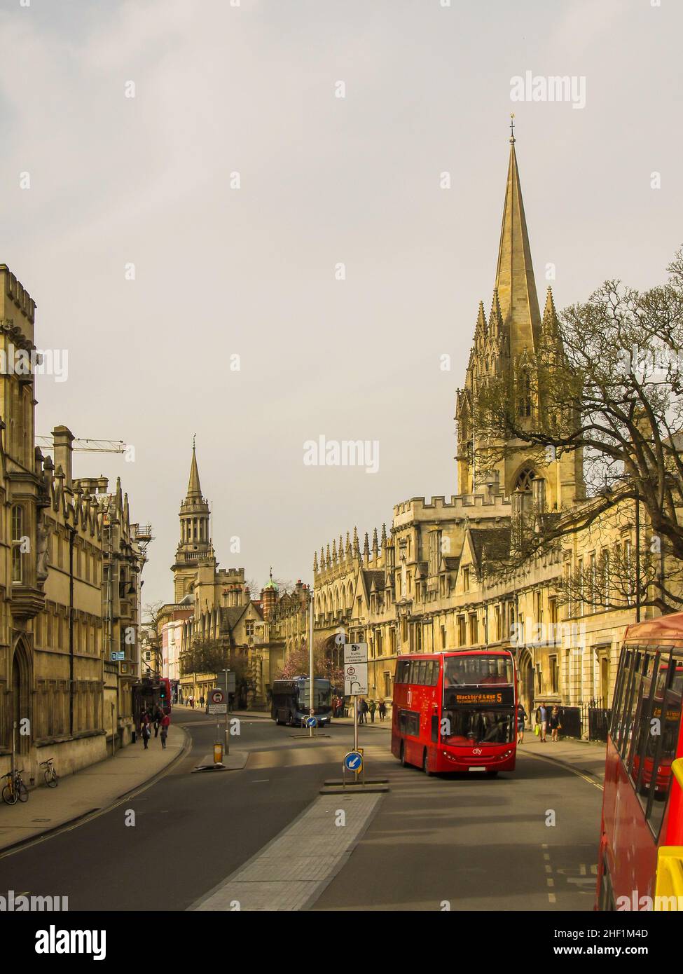 A street scene in Oxford, England, with the iconic British busses in a ...