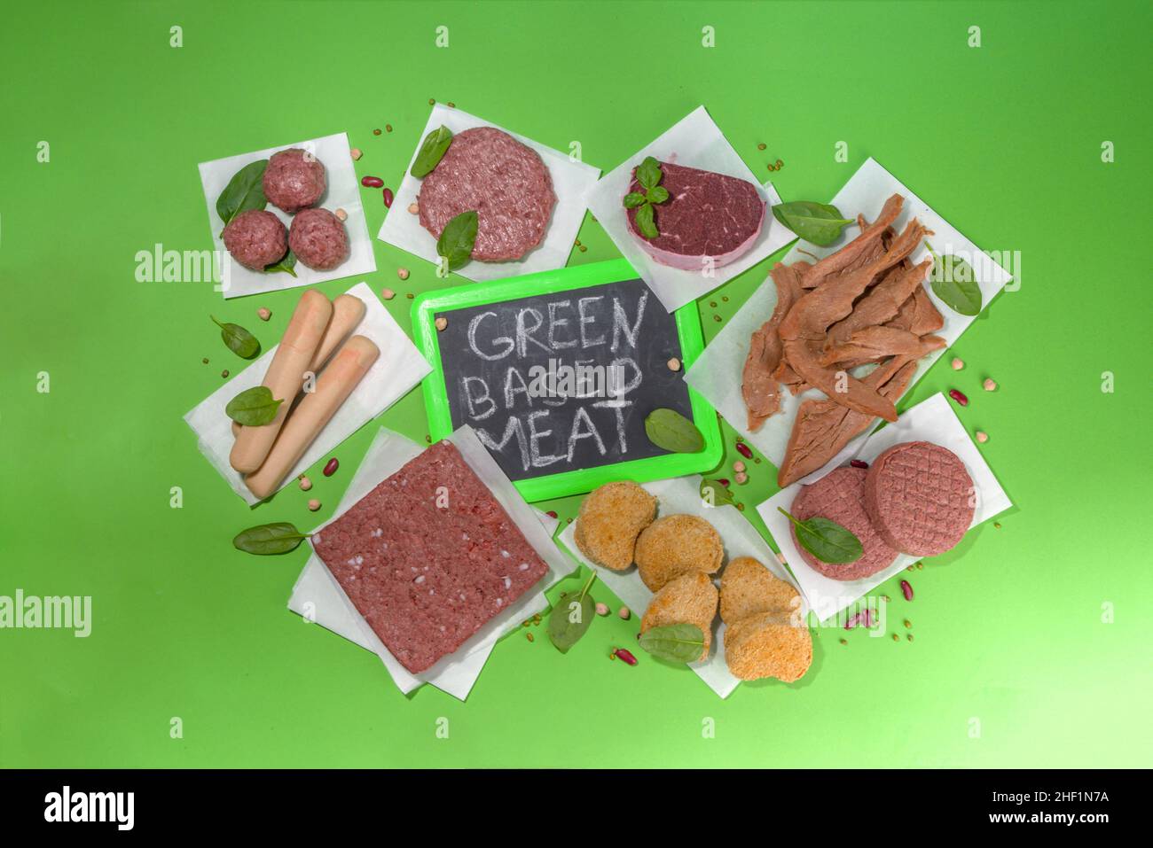 Lab-grown or plant based red meat steaks over green background Stock ...