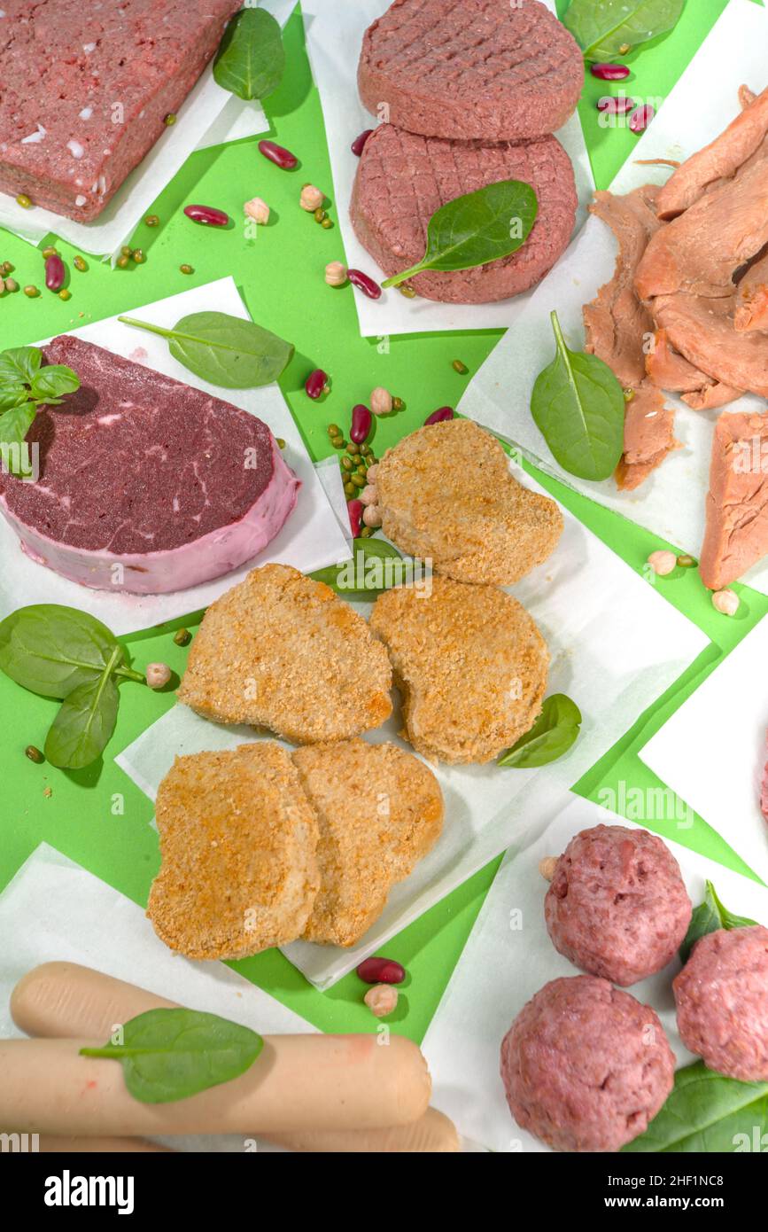 Lab-grown or plant based red meat steaks over green background Stock ...