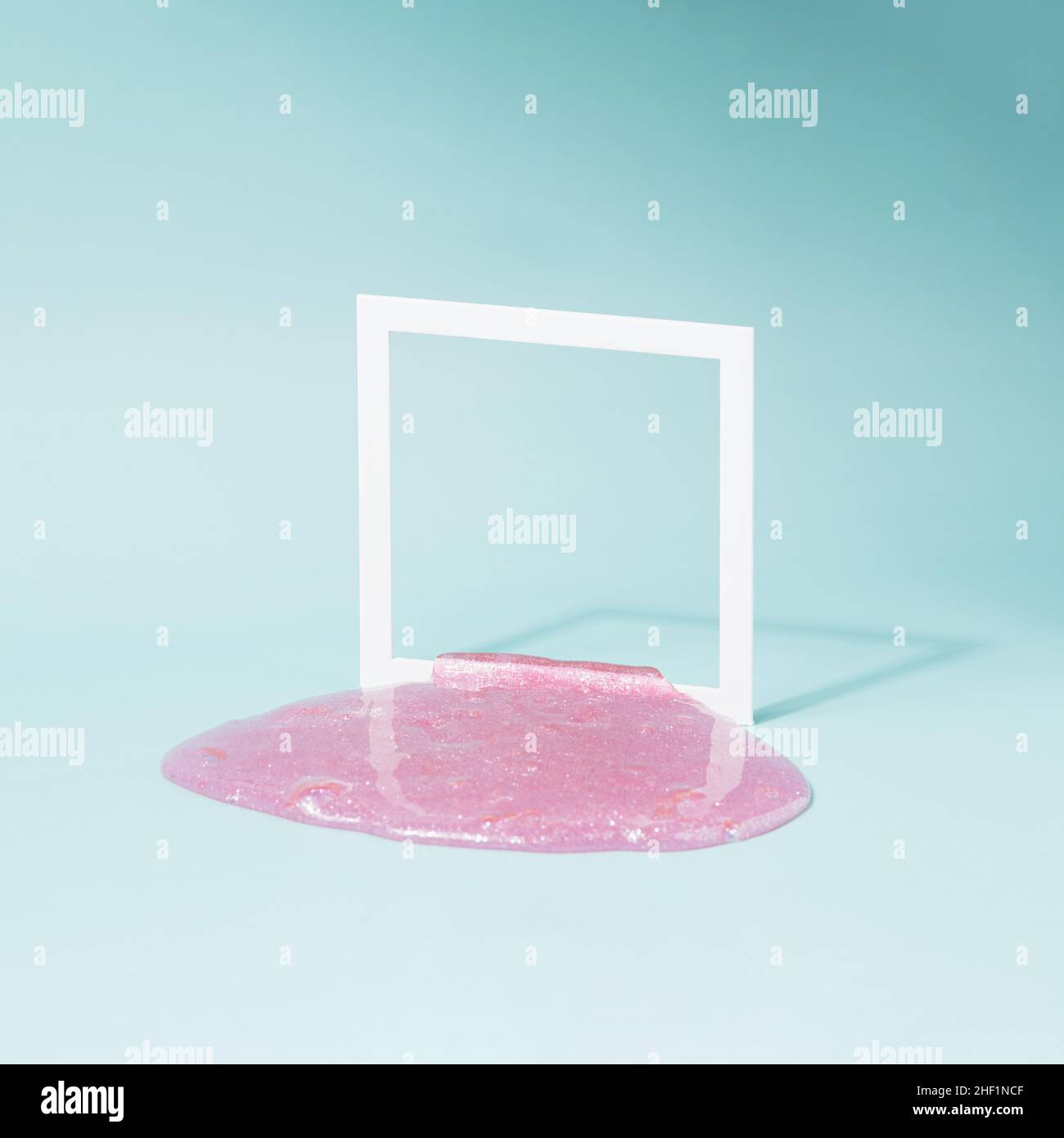 Pink slime spilling out of a square white frame on a pastel blue ...