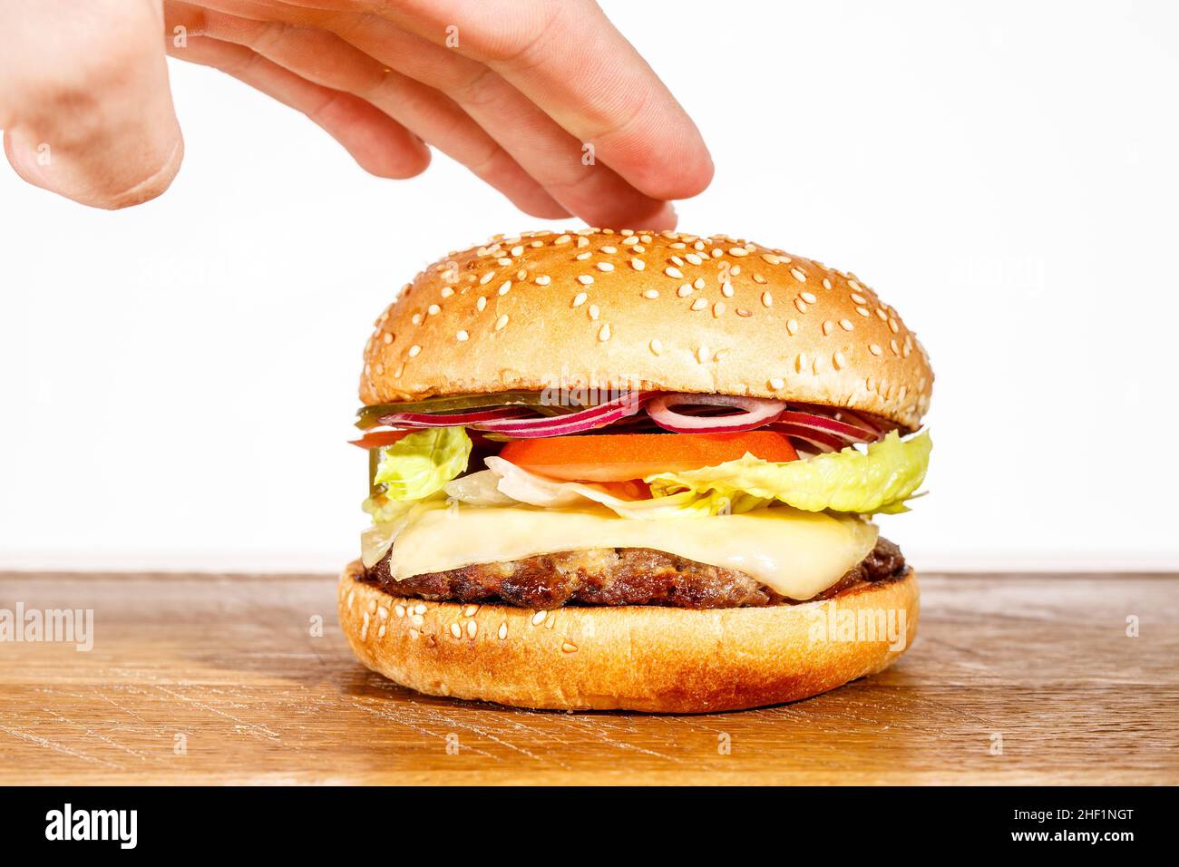 The Burger in the hand of the chef, Cook preparing and making hamburger ...